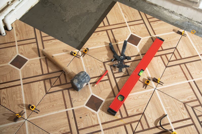 Laying Floor Ceramic Tile. Tools for Renovating Floor Stock Image ...