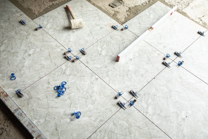 Laying Floor Ceramic Tile. Tools for Renovating Floor Stock Image ...