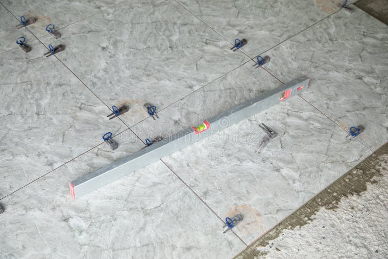 Laying Floor Ceramic Tile. Tools for Renovating Floor Stock Image ...