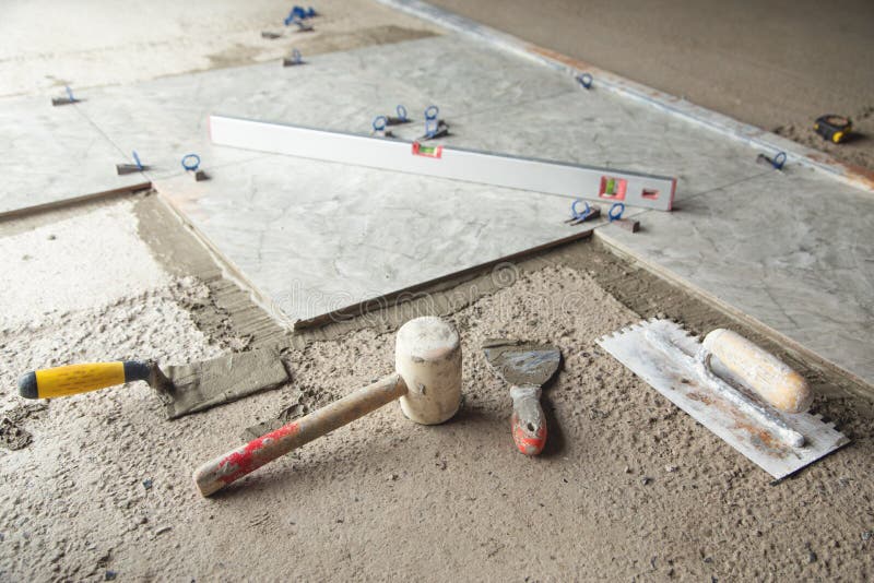 Laying Floor Ceramic Tile. Tools for Renovating Floor Stock Image ...