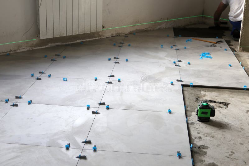 Laying Floor Tiles. Linear Level. Green Hand Gloves. Stock Image ...