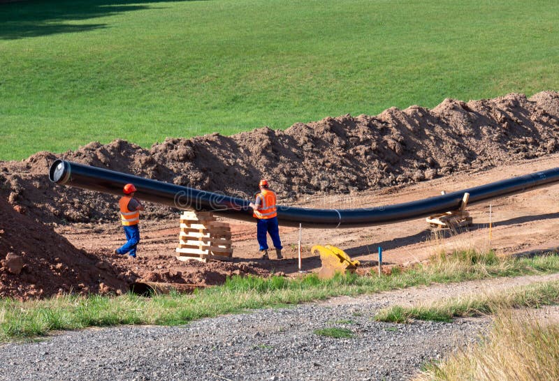 Laying a Gas Pipe Route on the Construction Site with Worker Stock ...