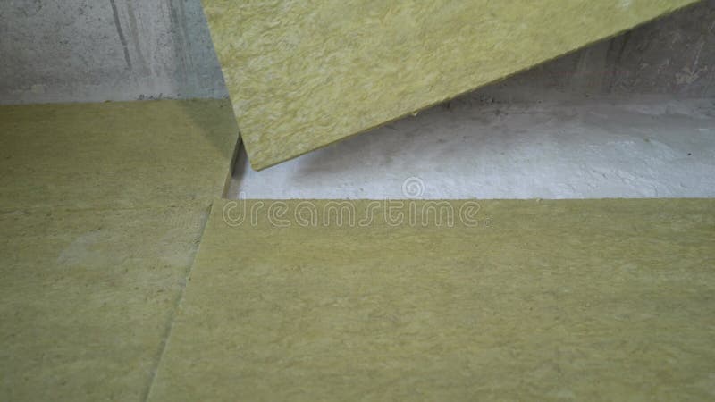 The Builder Insulates the Floors of the House with Glass Wool. Laying ...