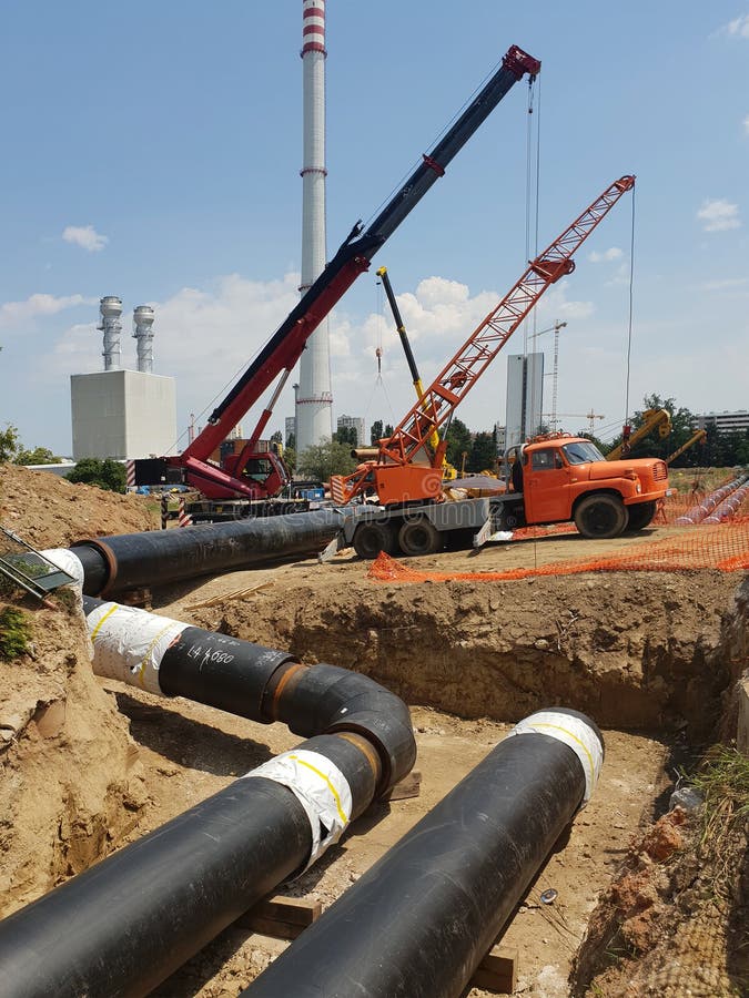 Laying Heating Pipes in a Trench at Construction Site Stock Photo ...