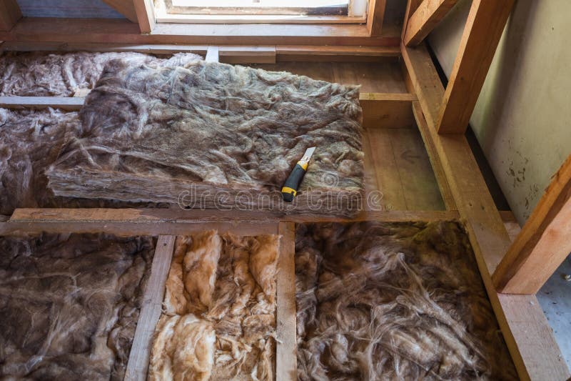 Laying Insulation on the Floor in a Frame House Under Construction ...