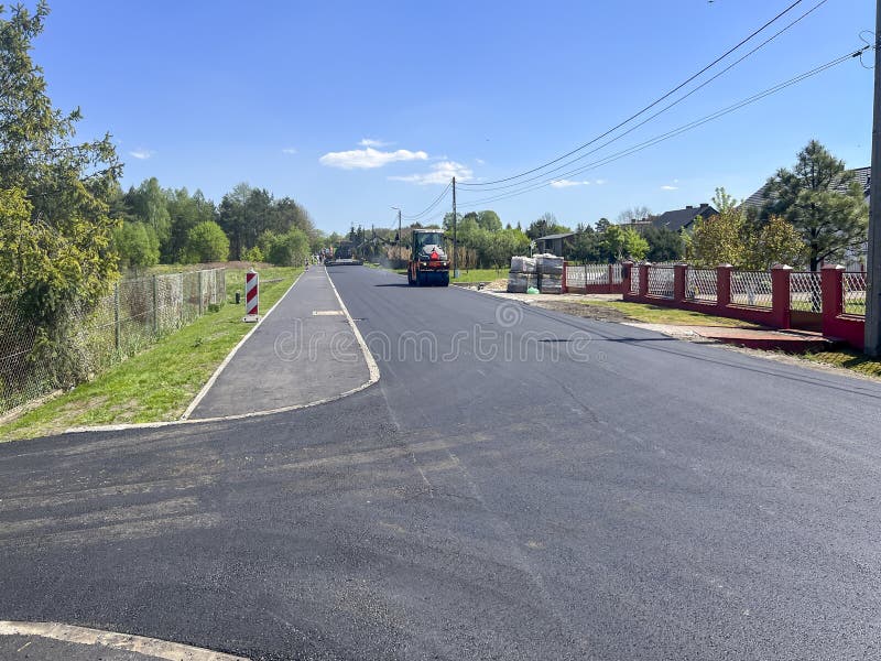 Laying the Last Layer of Asphalt on the Modernized Road and Sidewalk ...
