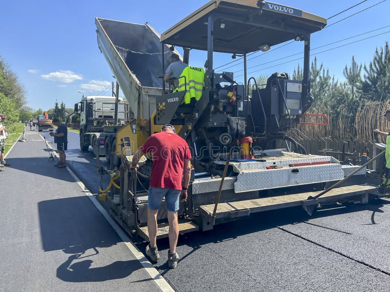 Laying the Last Layer of Asphalt on the Modernized Road and Sidewalk ...