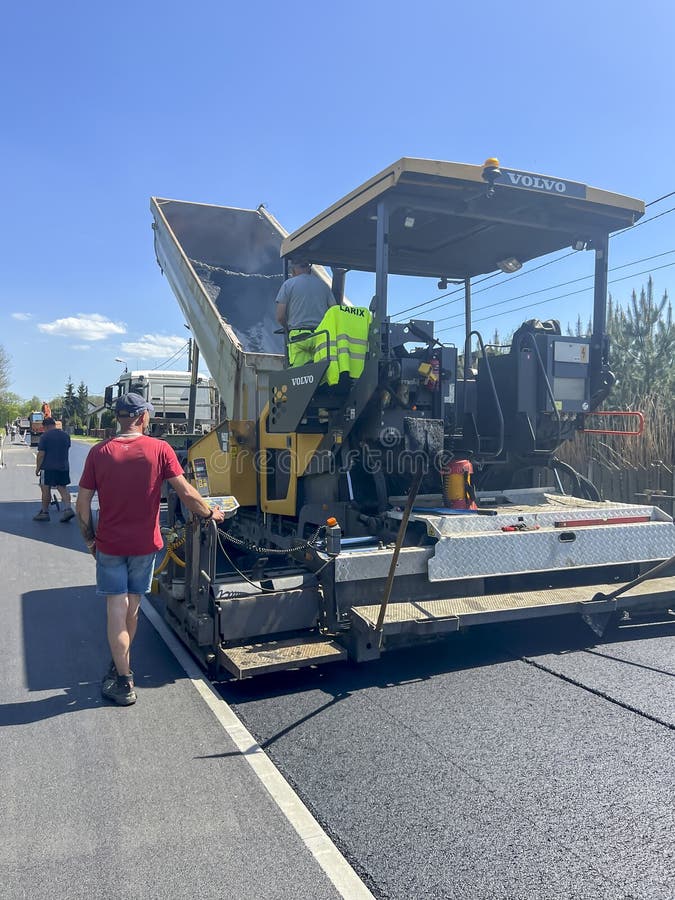 Laying the Last Layer of Asphalt on the Modernized Road and Sidewalk ...