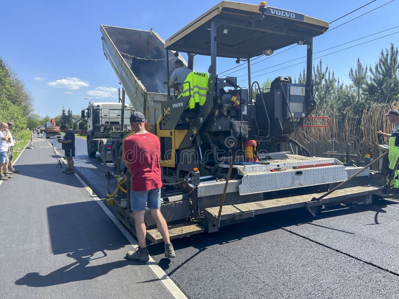 Laying the Last Layer of Asphalt on the Modernized Road and Sidewalk ...