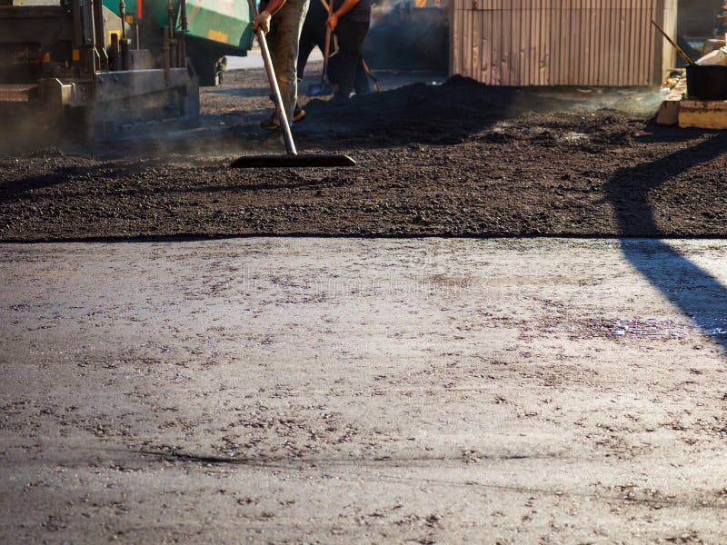 Laying New Asphalt. the Process of Leveling the Asphalt Manually Using ...