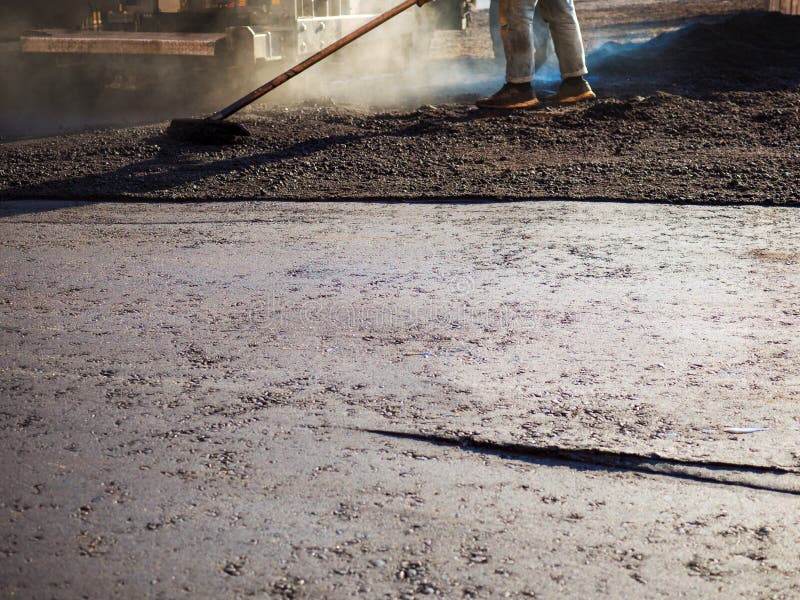 Laying New Asphalt. the Process of Leveling the Asphalt Manually Using ...