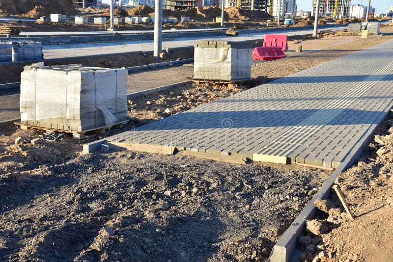 Laying Paving Slabs and Borders at Construction Site. Process of ...