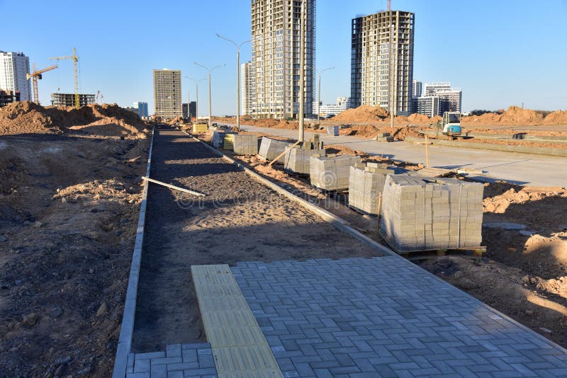 Laying Paving Slabs and Borders at Construction Site. Process of ...