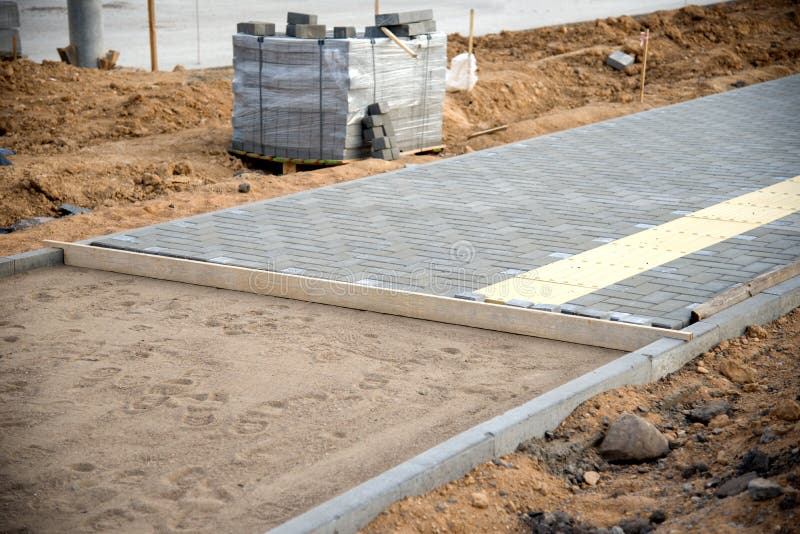 Laying Paving Slabs and Borders at Construction Site. Process of ...