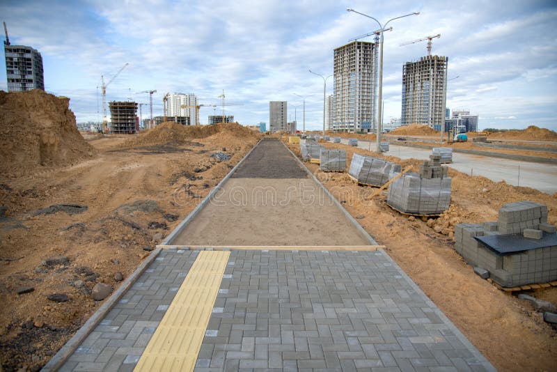 Laying Paving Slabs and Borders at Construction Site. Process of ...