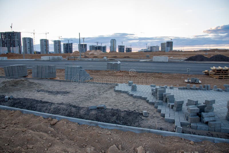 Laying Paving Slabs and Borders at Construction Site. Process of ...