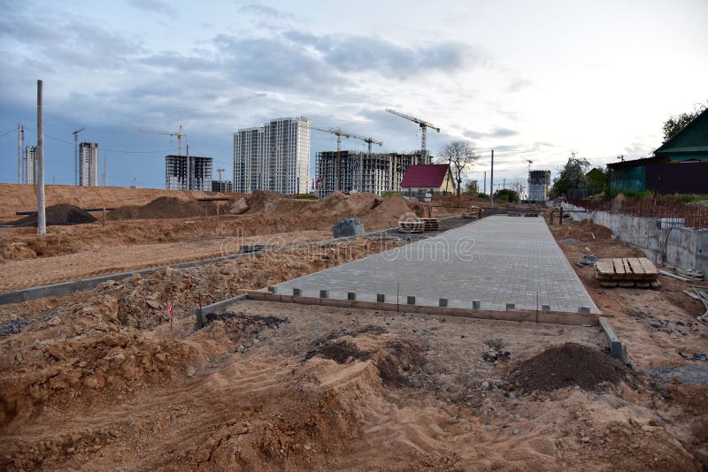 Laying Paving Slabs and Borders at Construction Site. Process of ...