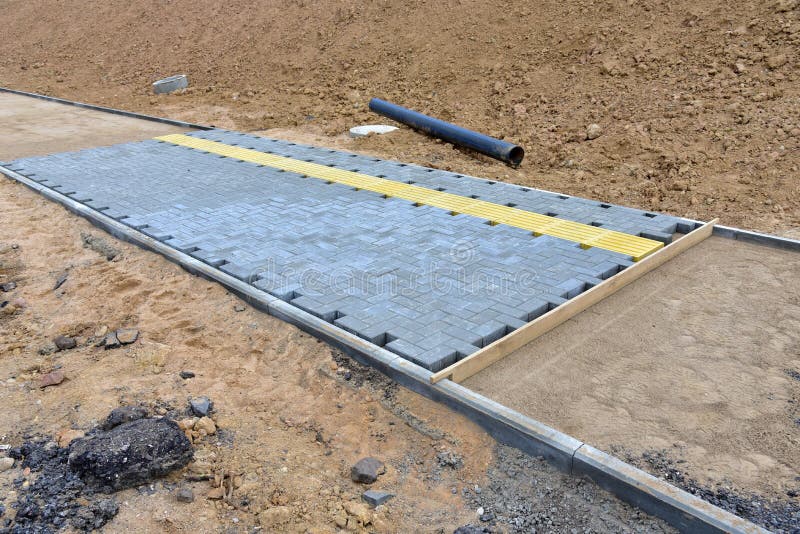 Laying Paving Slabs and Borders at Construction Site. Process of ...