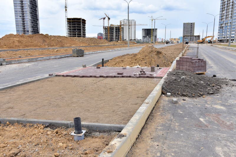 Laying Paving Slabs and Borders at Construction Site. Process of ...