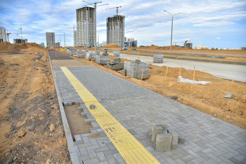 Laying Paving Slabs and Borders at Construction Site. Process of ...