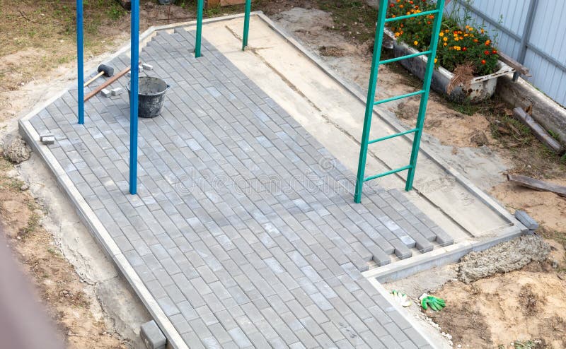 Laying Paving Slabs at a Construction Site. Stock Photo - Image of ...