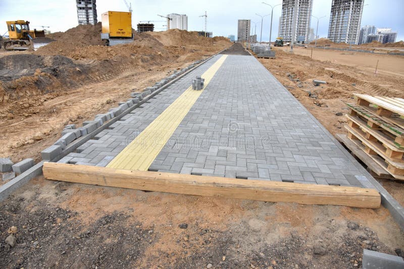 Laying Paving Slabs at Construction Site. Process of Installing Paving ...