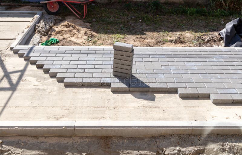 Laying Paving Slabs at a Construction Site. Stock Photo - Image of grey ...