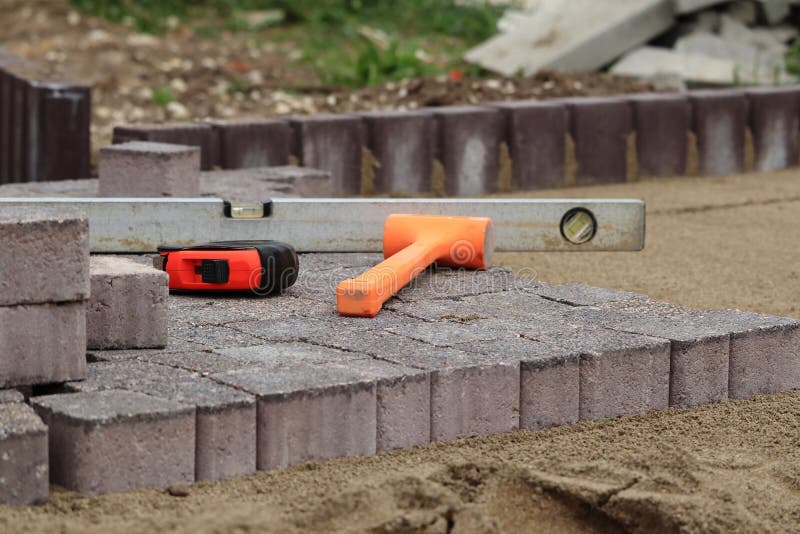 Laying Paving Stones. Paving Tools. Stock Photo - Image of cement ...