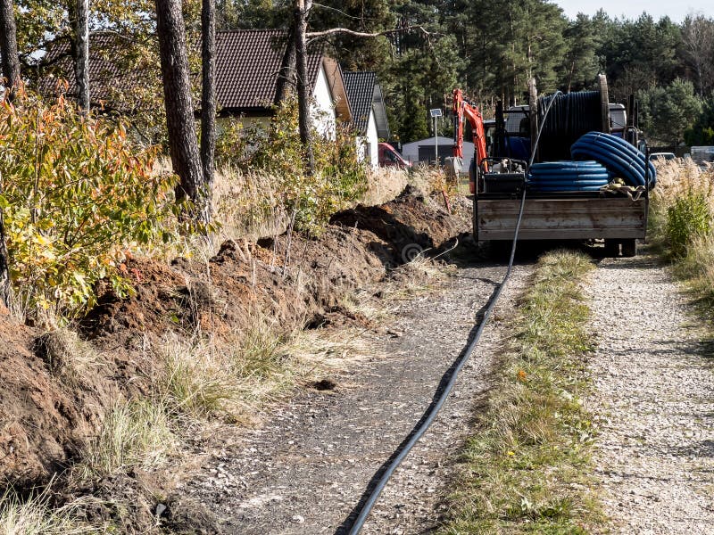 Laying the Power Cable in Trenches, in the Ground Along a Country Road ...