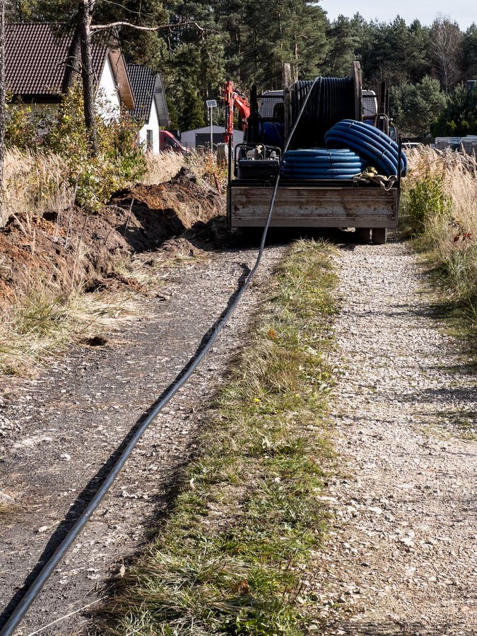 Laying the Power Cable in Trenches, in the Ground Along a Country Road ...