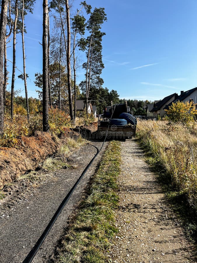 Laying the Power Cable in Trenches, in the Ground Along a Country Road ...