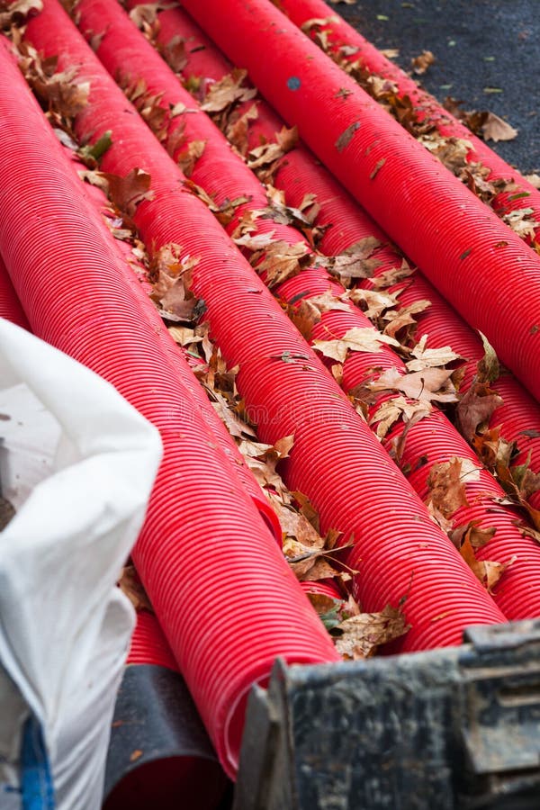 Laying red water pipe stock image. Image of industry - 77265817