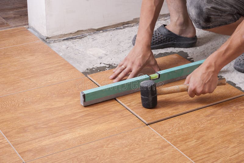 Laying tiles on the floor stock image. Image of construction - 77222187