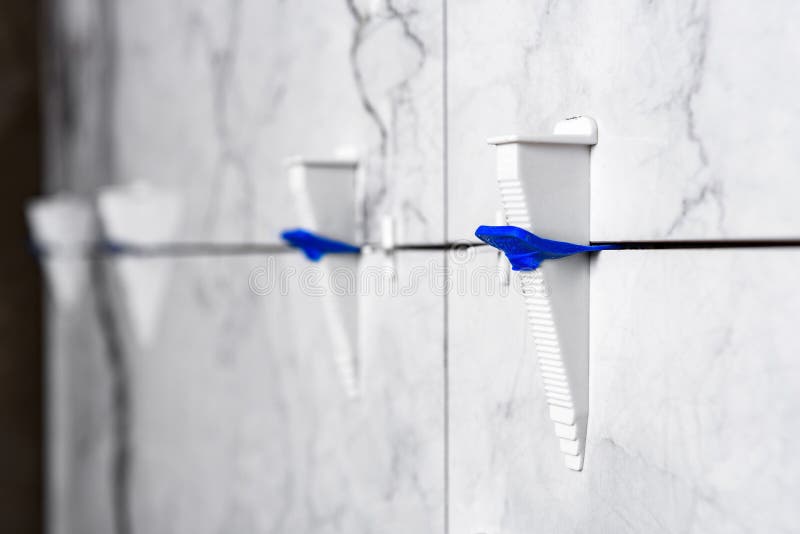 Laying Tiles with Leveling System Tiles in Bathroom. Stock Image ...