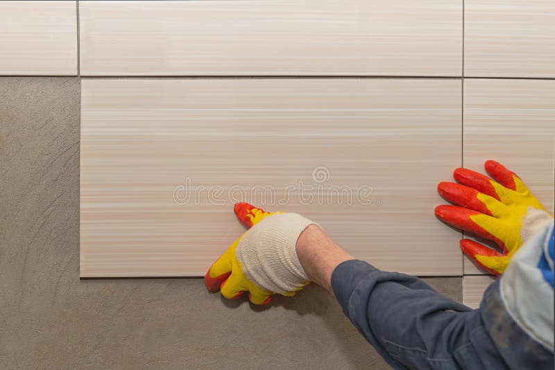 Laying tiles on the wall stock photo. Image of actions - 84692476