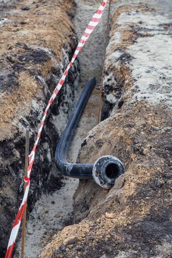 Laying Water Pipes in a Trench Stock Photo - Image of hole, line: 64585944