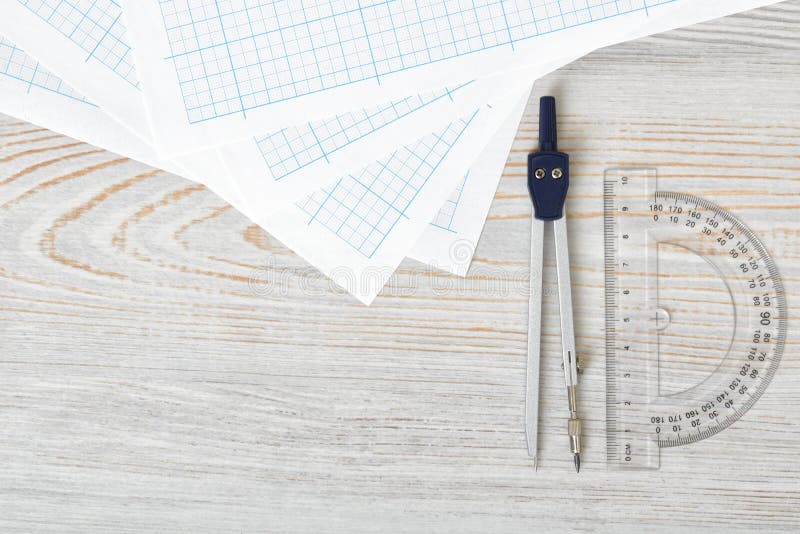 Layout with Compass, Protractor and Graph Paper on Wooden Surface in ...