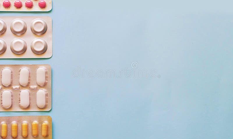 Layout of Tablets and Capsules on a Plain Blue Background Stock Image ...
