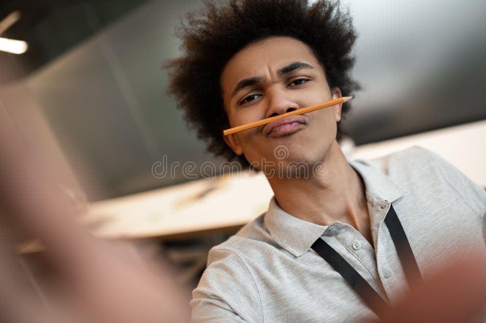 Lazy Man Having Fun in Workplace with Pencil in Office Stock Photo ...
