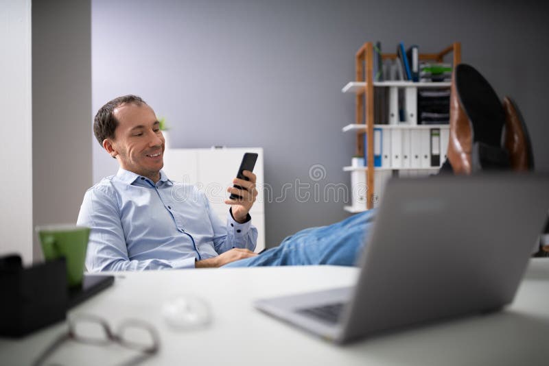 Lazy Man Using Phone at Work Stock Image - Image of confused, freelance ...