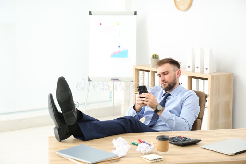 Lazy Office Employee with Mobile Phone at Workplace Stock Photo - Image ...
