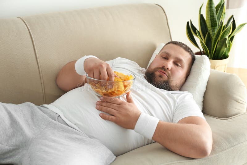 Lazy Overweight Man Eating Chips on Sofa Stock Image - Image of resting ... Lazy Overweight Man Eating Chips on Sofa Stock Image - Image of resting ...