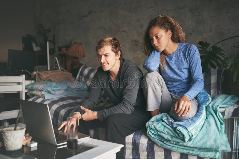 Lazy Weekends are for Lounging Around. a Young Couple Using a Laptop on ...