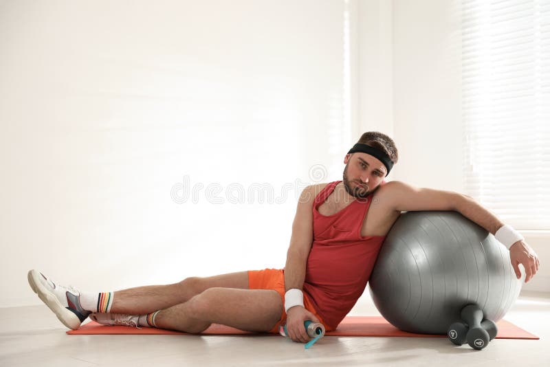 Lazy Young Man with Sport Equipment on Yoga Mat. Space for Text Stock ... Lazy Young Man with Sport Equipment on Yoga Mat. Space for Text Stock ...