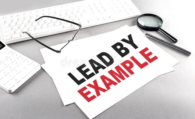 LEAD by EXAMPLE Text on a Paper with Keyboard, Calculator on Grey ...