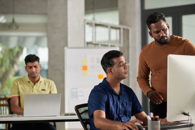 Lead UX Designer Helping Colleague Stock Image - Image of businessman, desk: 262902837