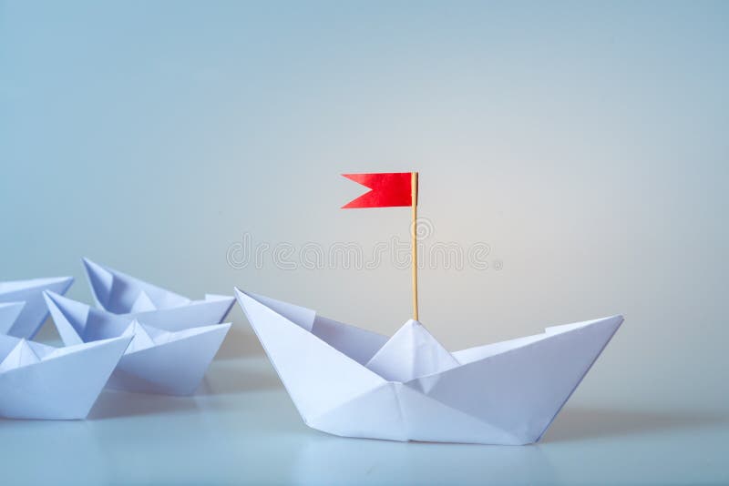 Leadership Concept Using Paper Ship with Red Flag on Blue Background ...