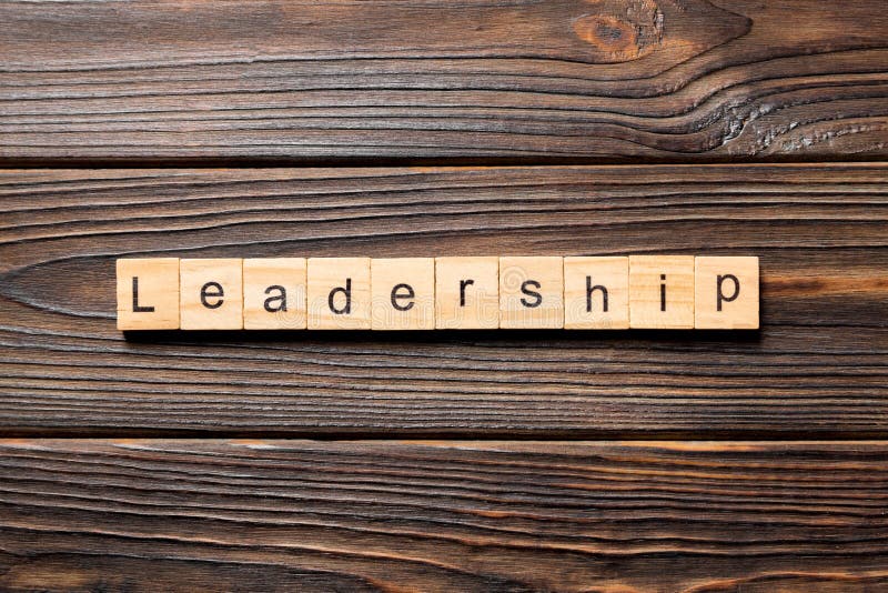 LEADERSHIP Word Written on Wood Block. LEADERSHIP Text on Table ...