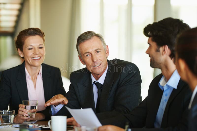 Leading the Meeting with Experience. a Group of Businesspeople Having a ... Leading the Meeting with Experience. a Group of Businesspeople Having a ...