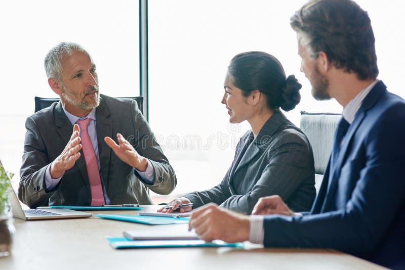 Leading Them through His Vision. Shot of a Group of Executives Having a ... Leading Them through His Vision. Shot of a Group of Executives Having a ...